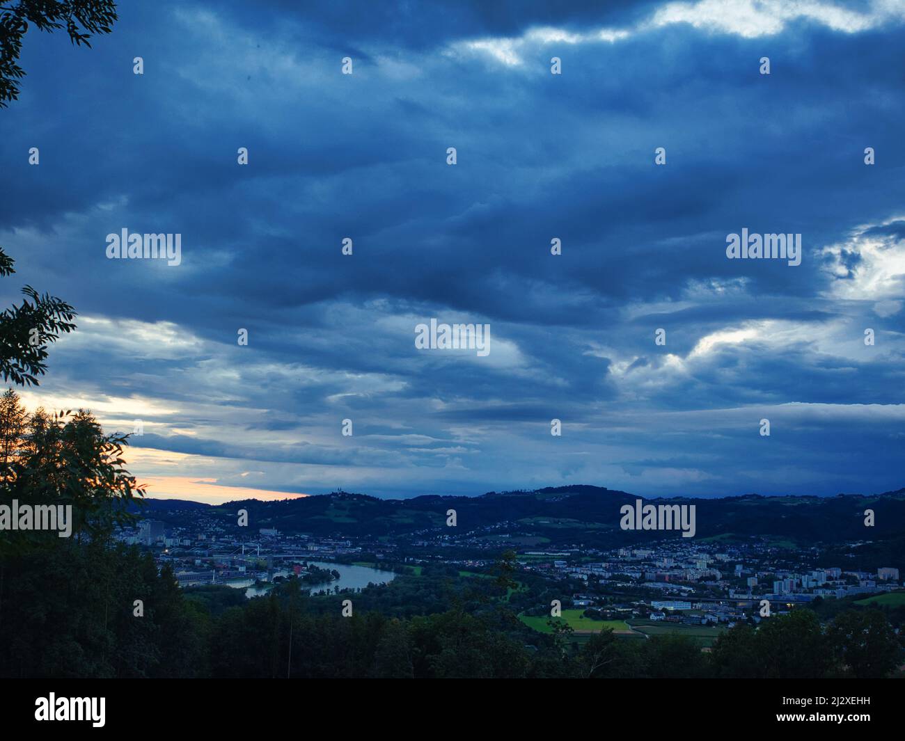 gloomy sky over city, panorama of a city at the Danube with dark sky ...