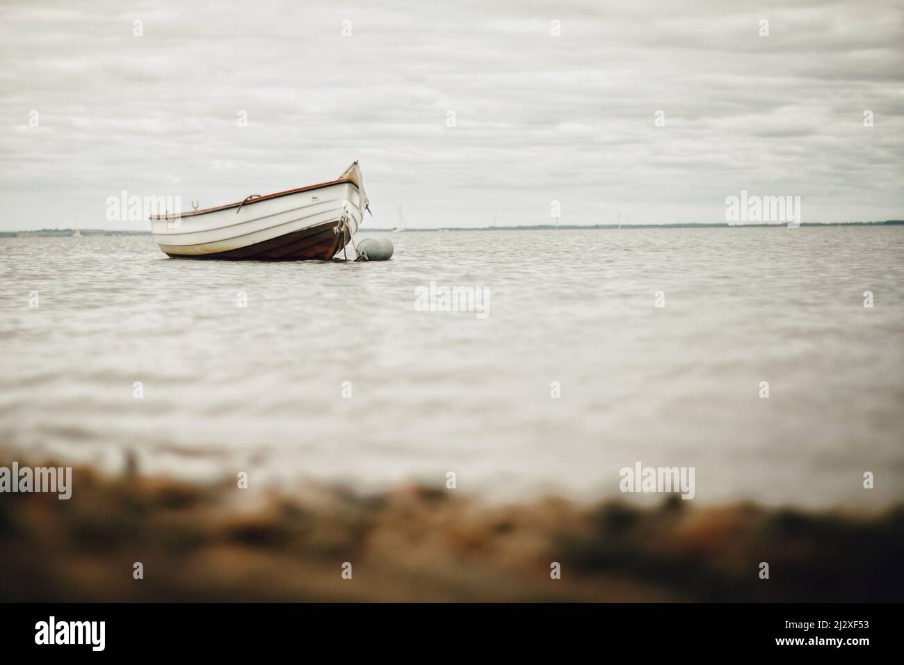The empty boat on the water surface against the cloudy sky Stock Photo ...