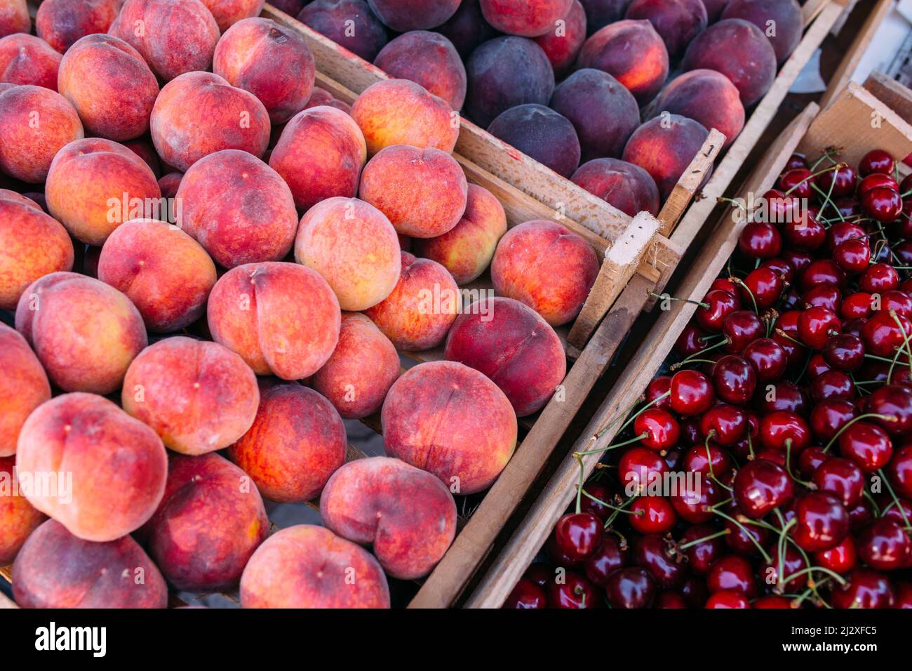 Fresh ripe fruits on the market in boxes Stock Photo - Alamy