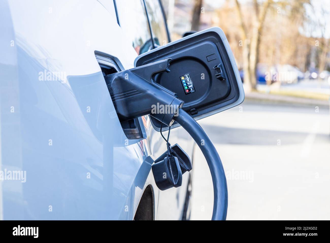 Electric vehicle or EV car with the power cable supply plugged in Stock ...