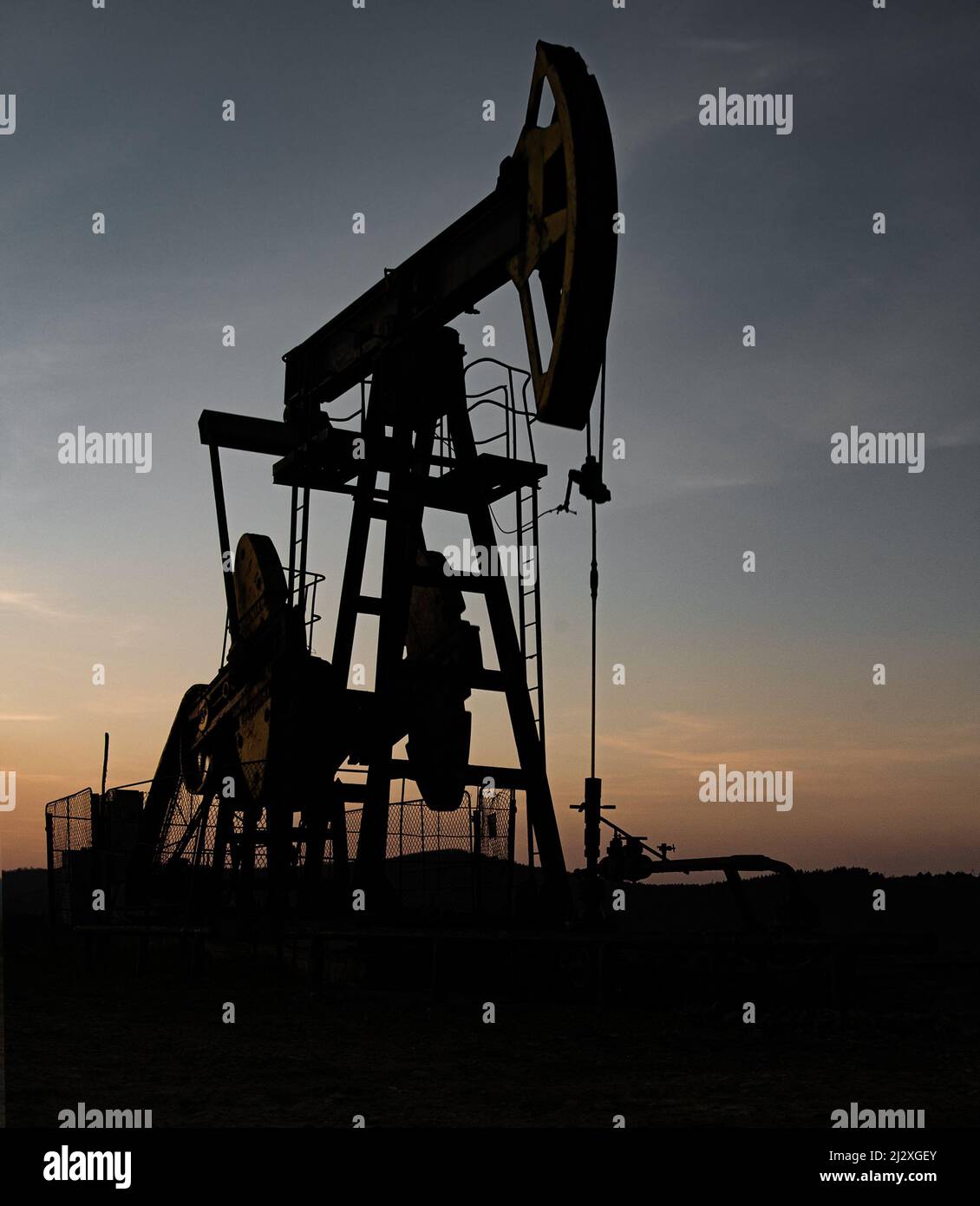 Oil pump oil rig energy industrial machine for petroleum in the sunset ...