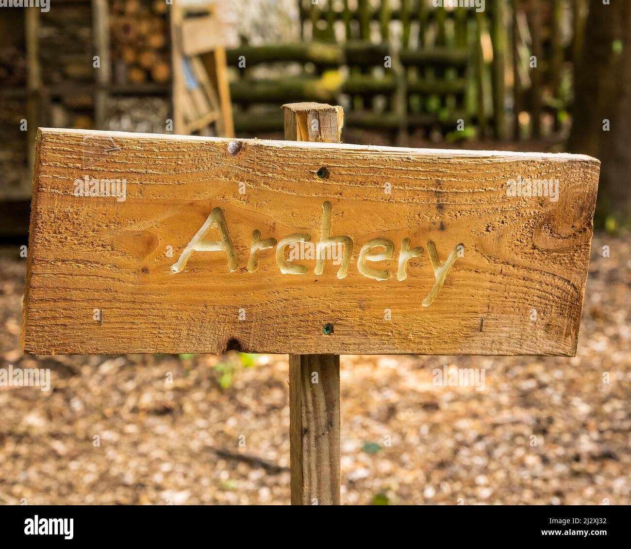 A wooden garden sign with Archery carved into it Stock Photo - Alamy