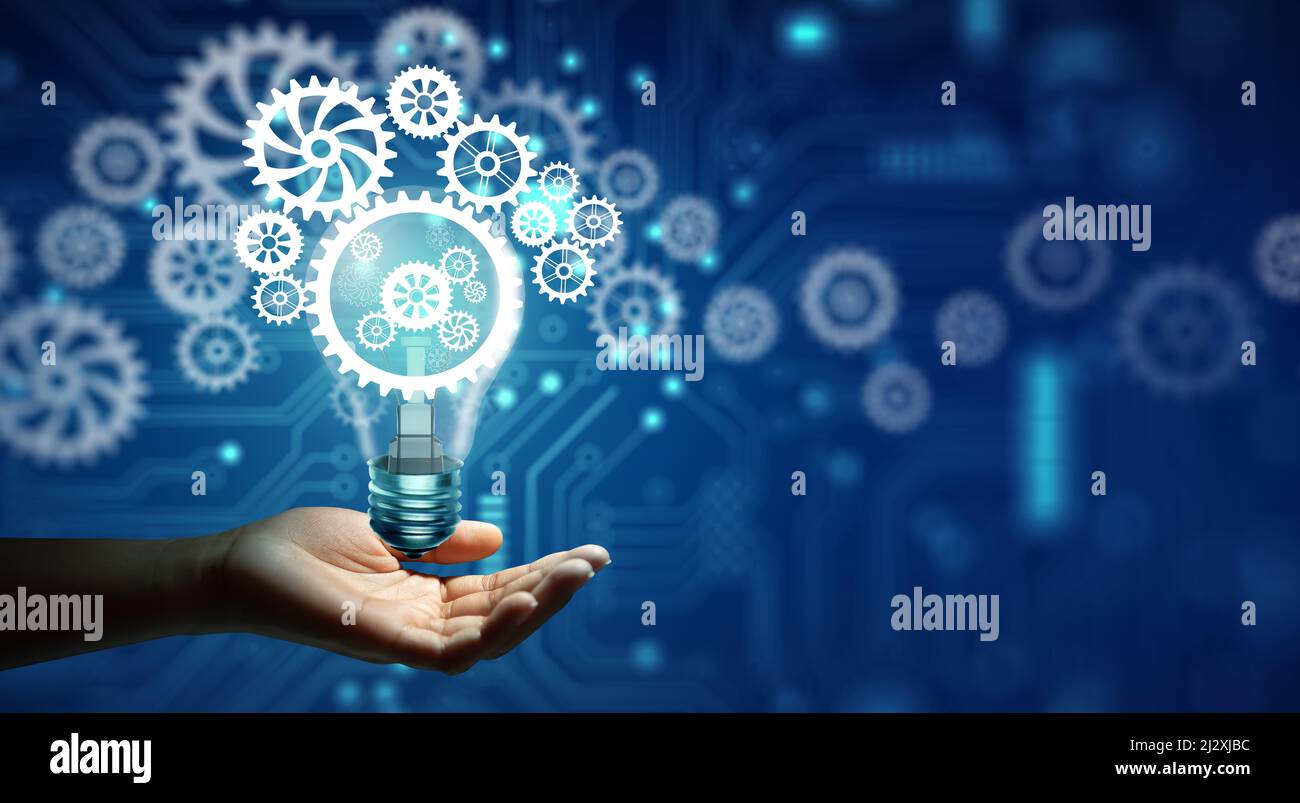 Hand holding Creative light bulb with cog inside and technology ...