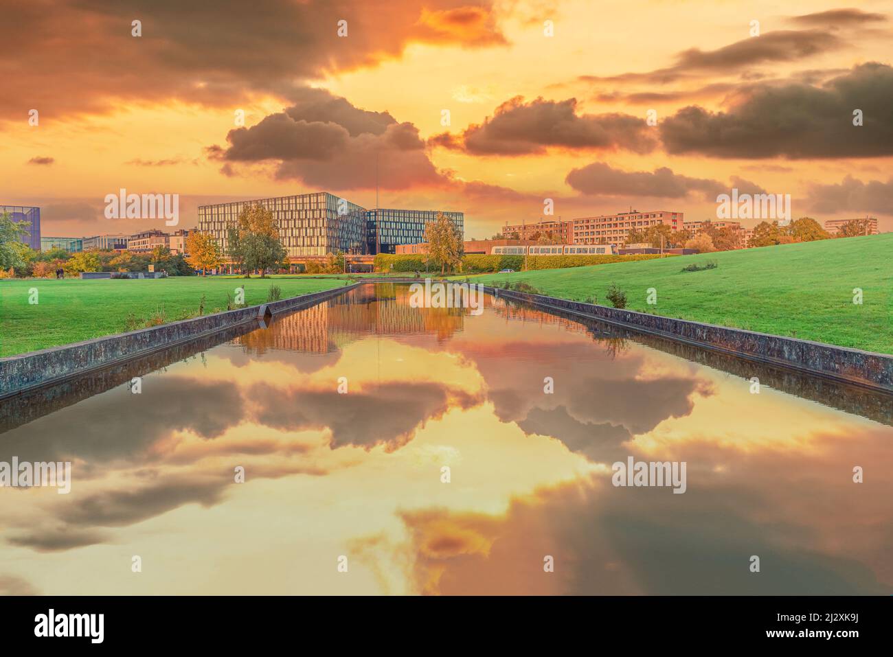 Beautiful yellow sunset with clouds over a river channel with ...