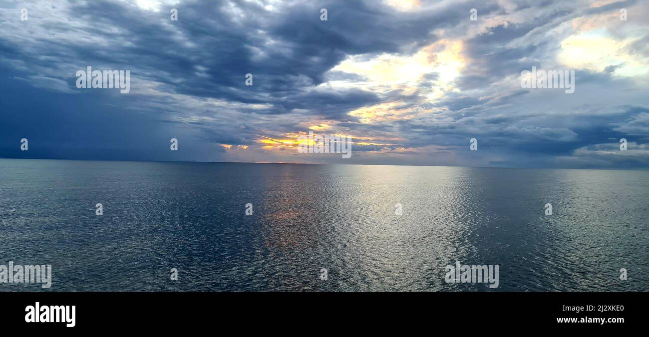 Calm sea and stormy sk Stock Photo - Alamy
