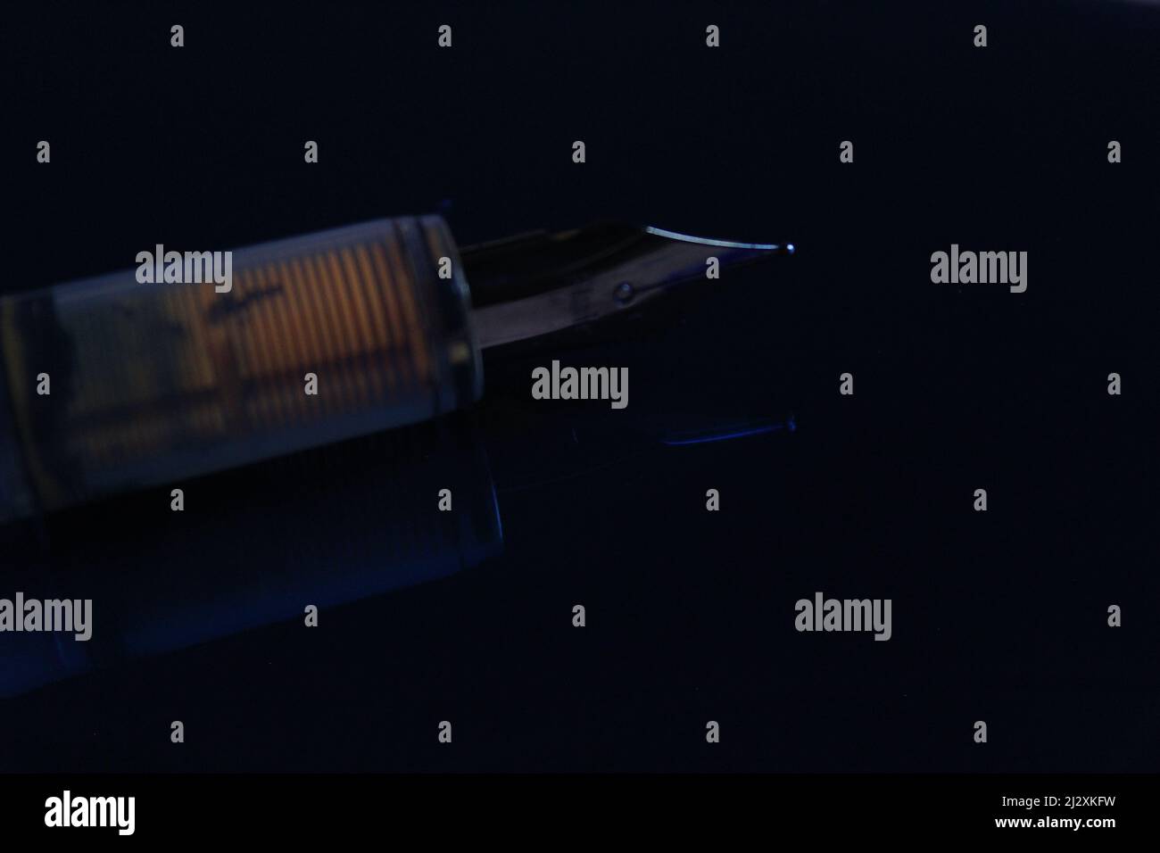 Dark blue ink pen with transparent body Stock Photo - Alamy