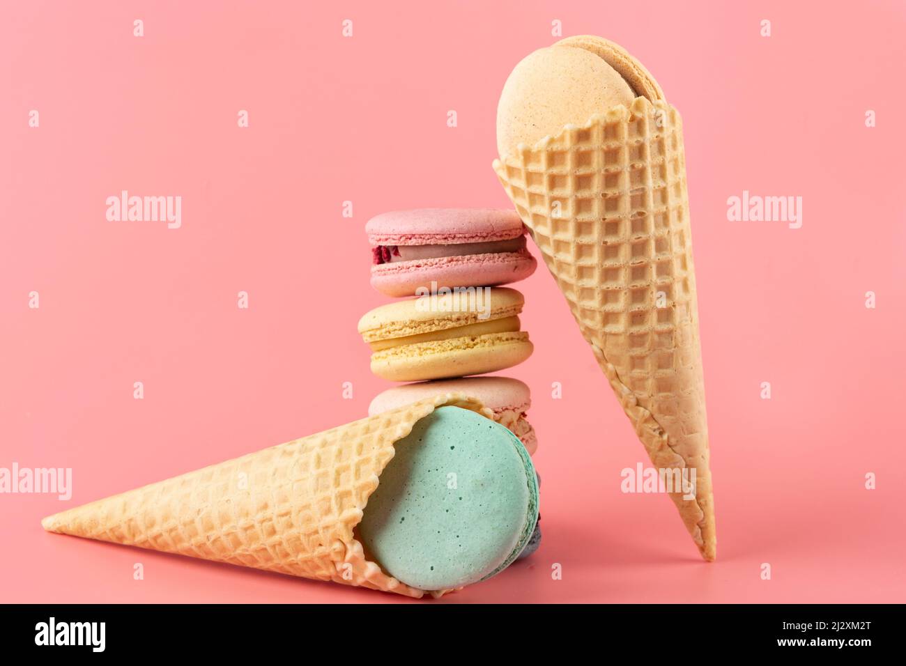 Macaroons stacked on a pink background. Delicious dessert of French ...