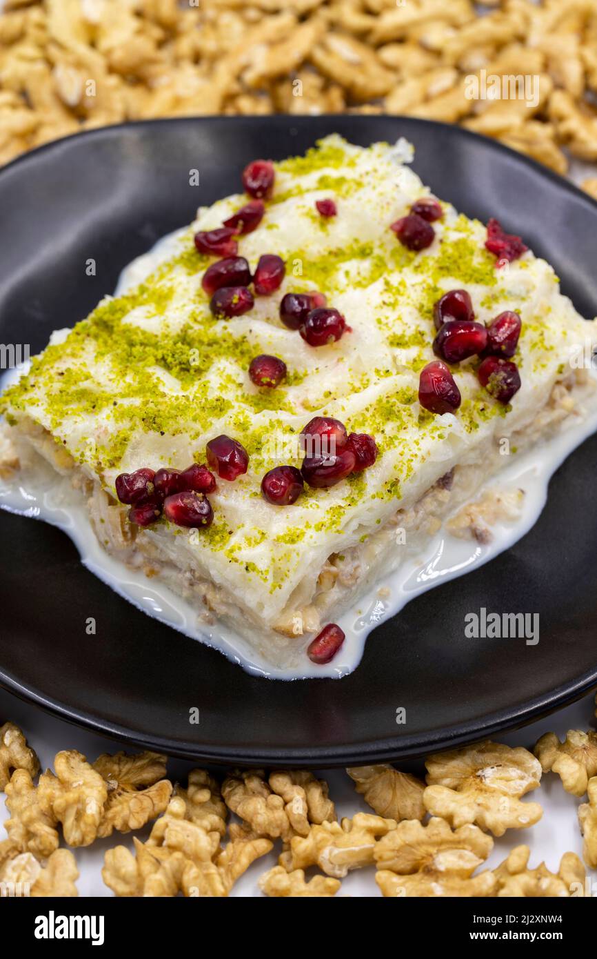 Gullac dessert. Traditional Turkish dessert sprinkled with walnuts ...