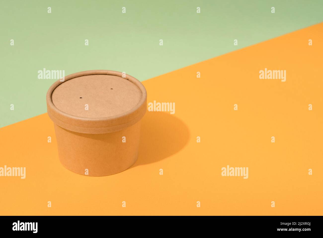 Disposable kraft paper street food container or cup with paper cap on ...