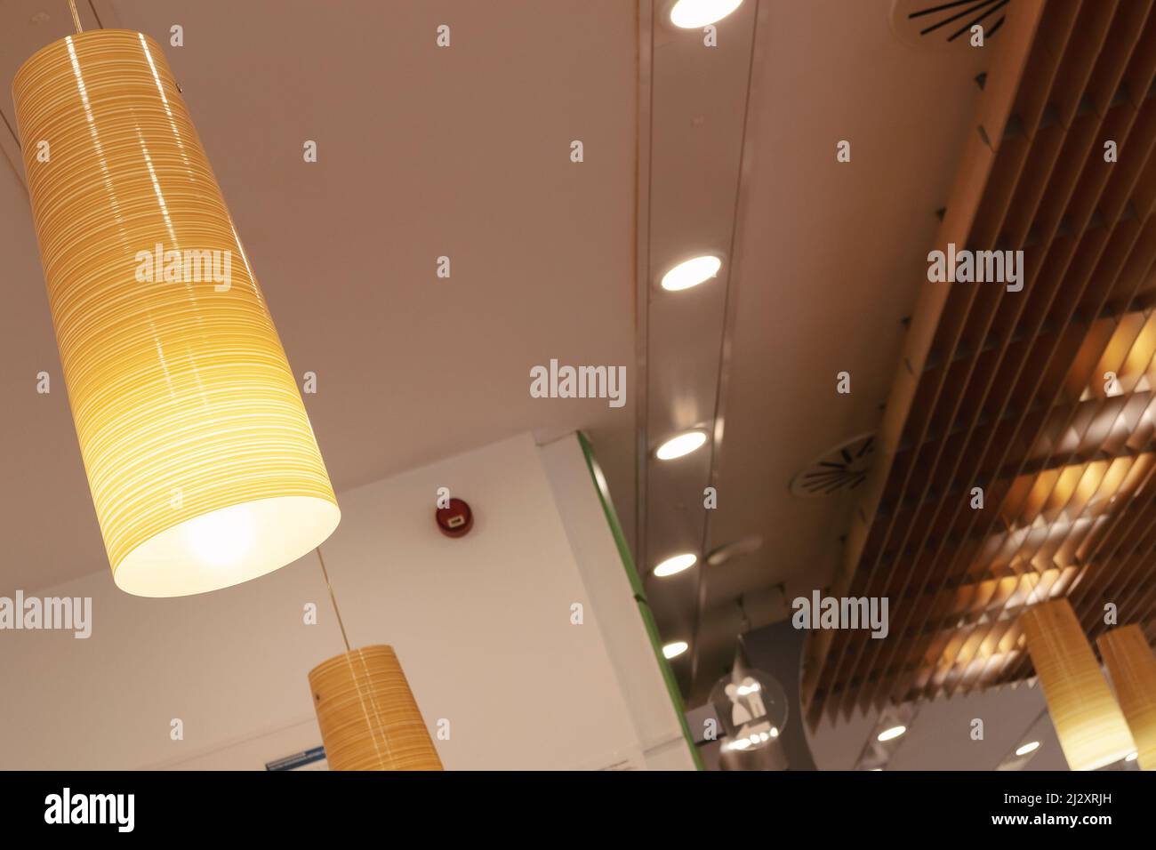 Modern ceiling lighting, details of lamps and wooden constructions ...