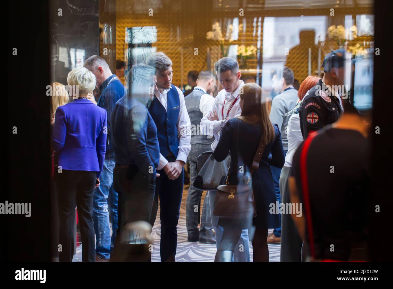 Public event. Spectators at the conference behind glass showcases Stock ...