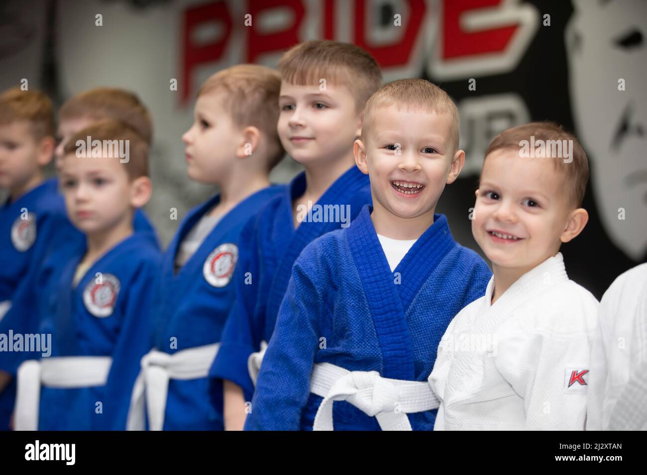 Judo school for children. A group of small children in kimanos lined up ...