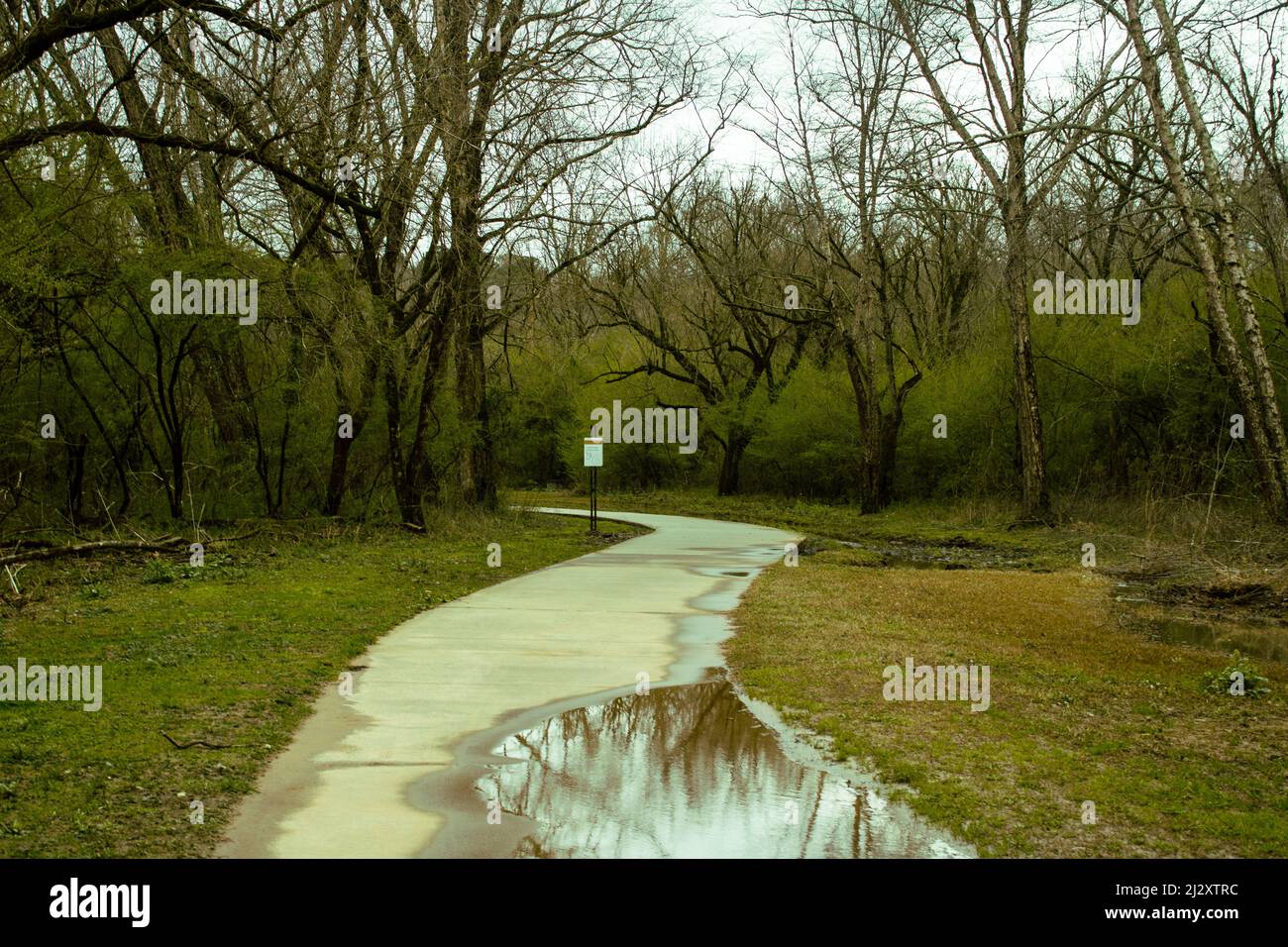 A beautiful view of a narrow curved trail in Suwanee Town Center Park ...
