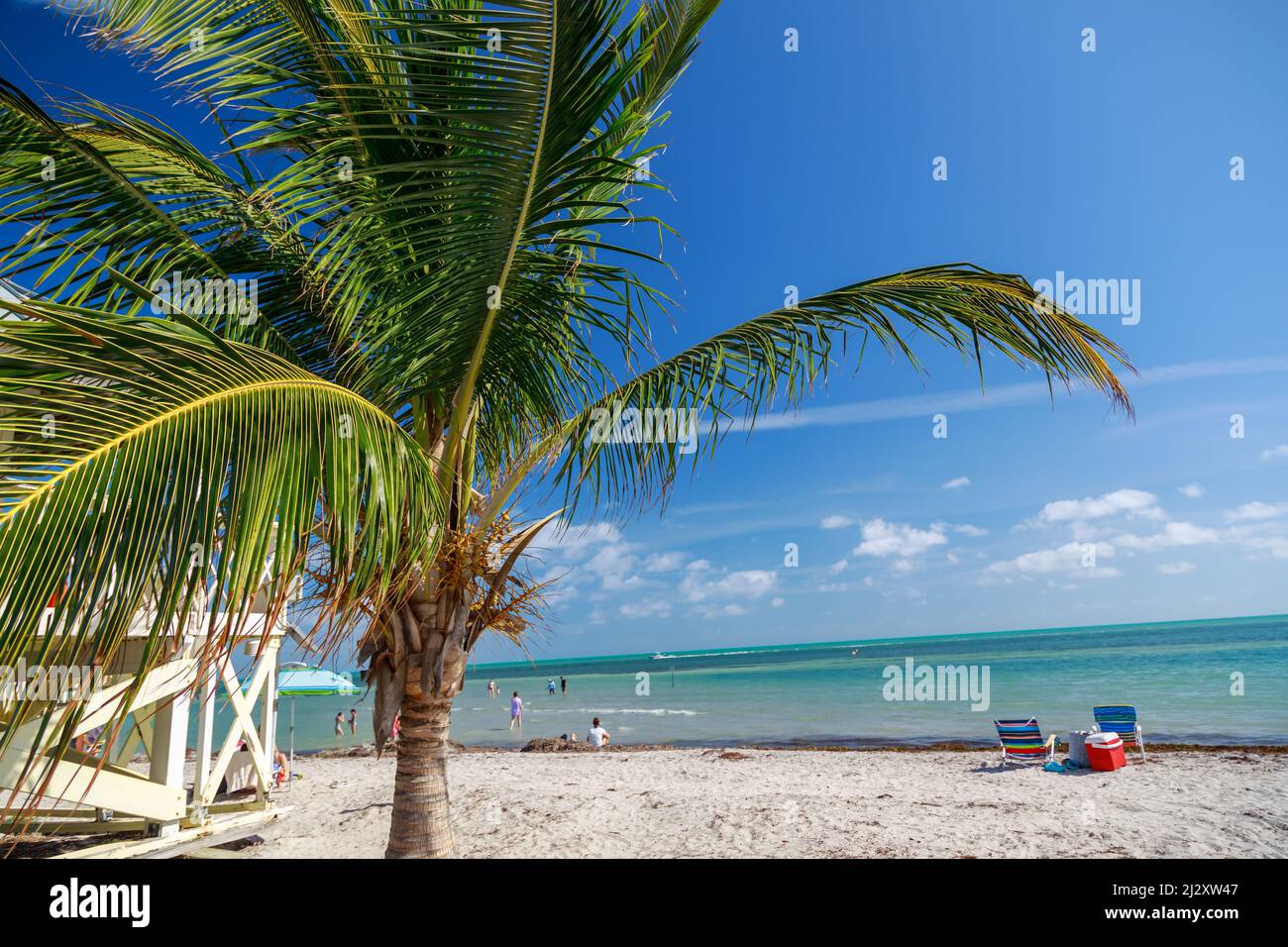 A beautiful view of the calm ocean gleaming under the cloudy blue sky ...
