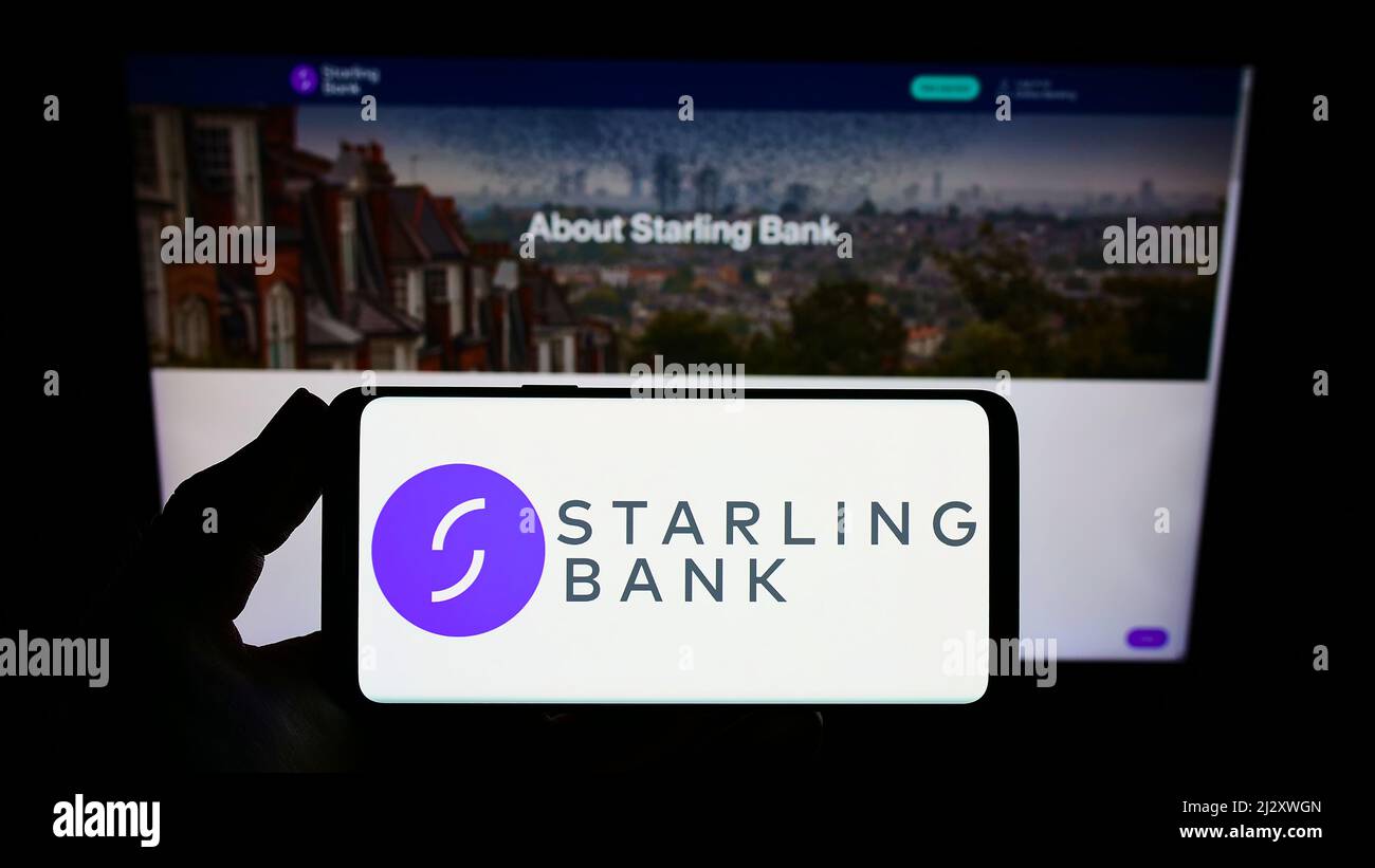 Person holding smartphone with logo of British challenger bank Starling ...