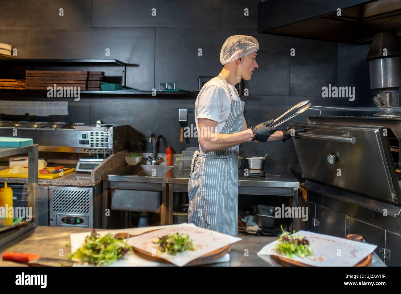 A chief-cooker working in the kitchen in the restaurant Stock Photo - Alamy