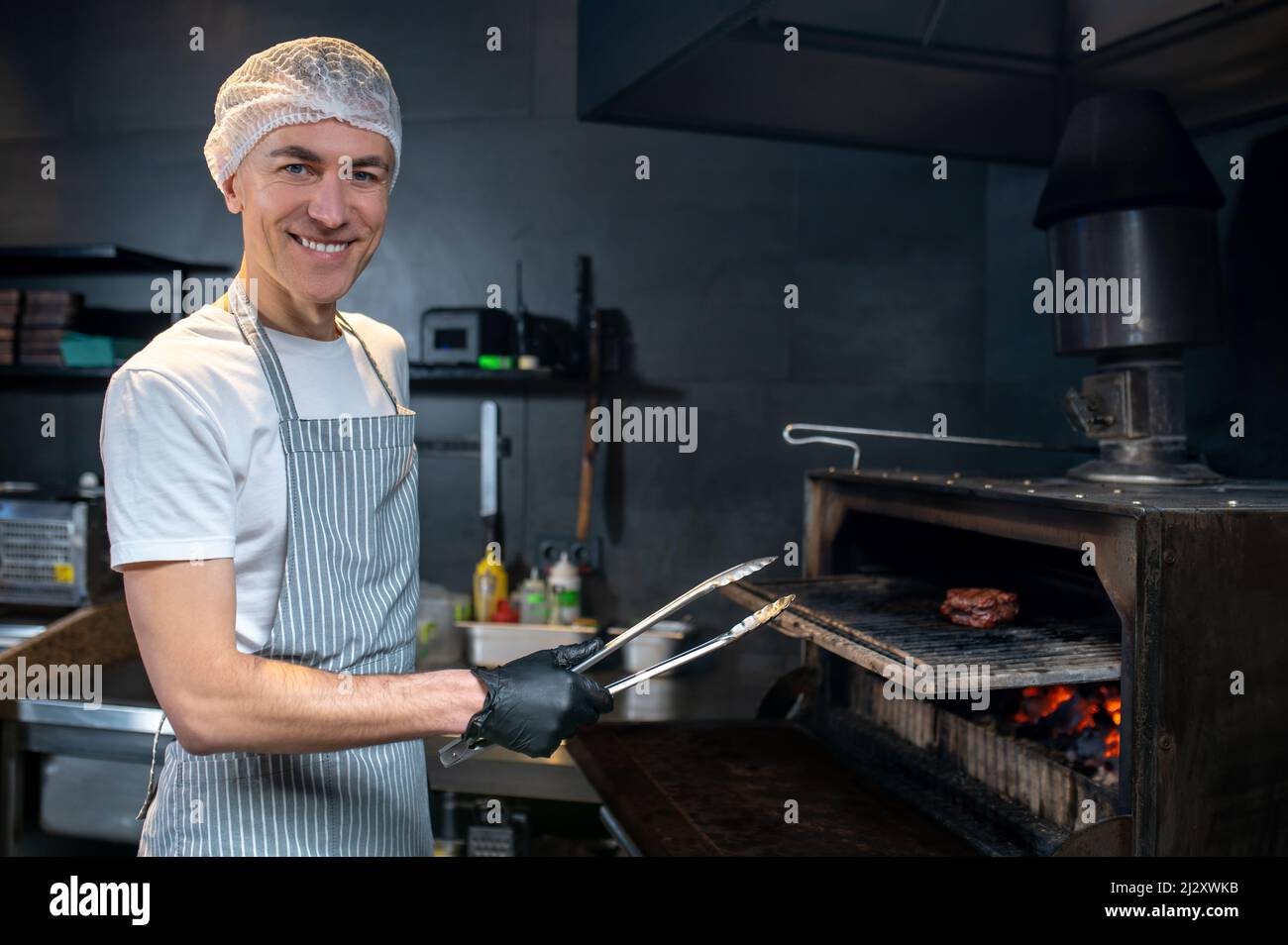 A chief-cooker cooking in the kitchen in the restaurant Stock Photo - Alamy