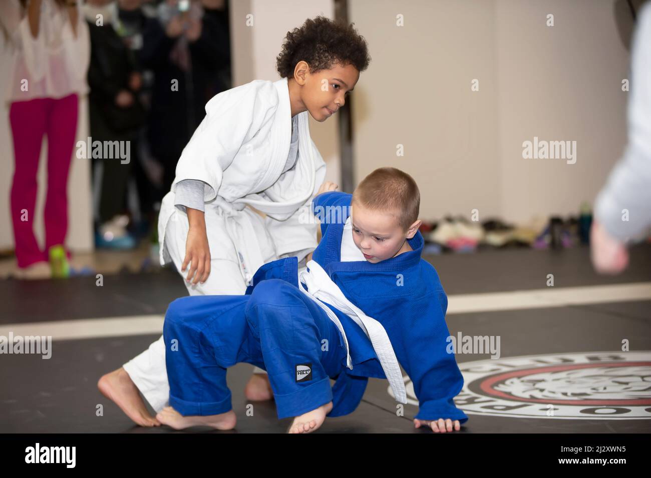 Judo school for children. Children in kimano show throws in the gym ...