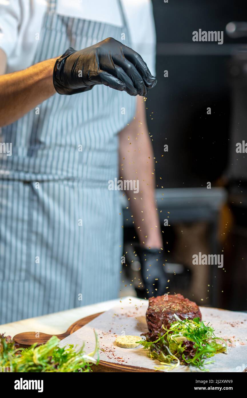 A chief-cooker cooking in the kitchen in the restaurant Stock Photo - Alamy
