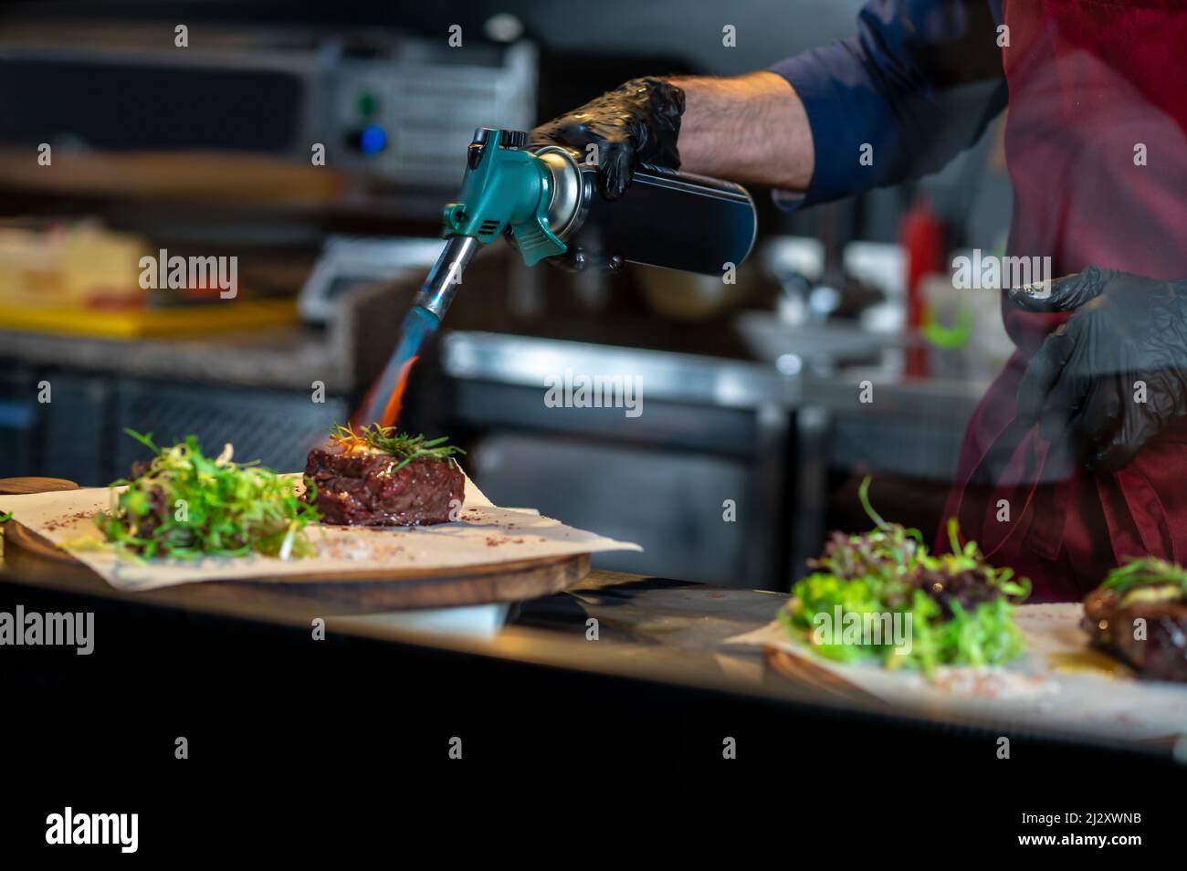 A chief-cooker cooking in the kitchen in the restaurant Stock Photo - Alamy