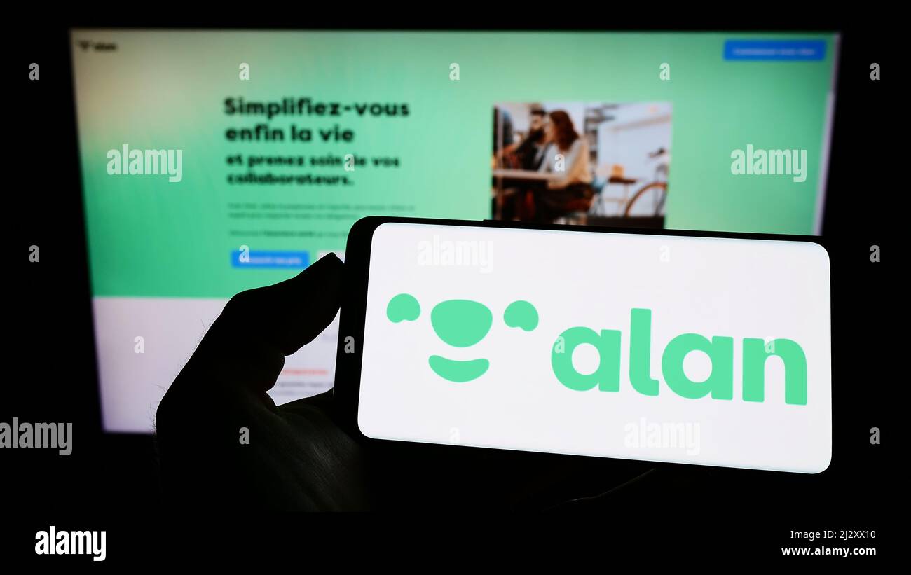 Person holding cellphone with logo of French health insurance company ...