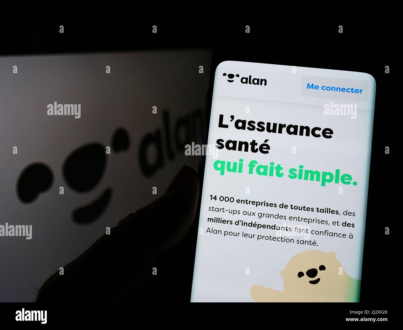 Person holding cellphone with webpage of French health insurance ...