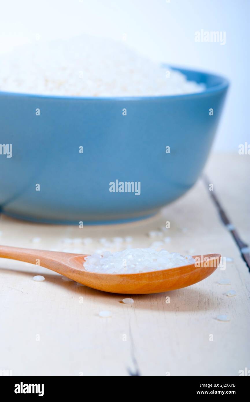 raw white rice on wood spoon and blue bowl extreme close up Stock Photo ...