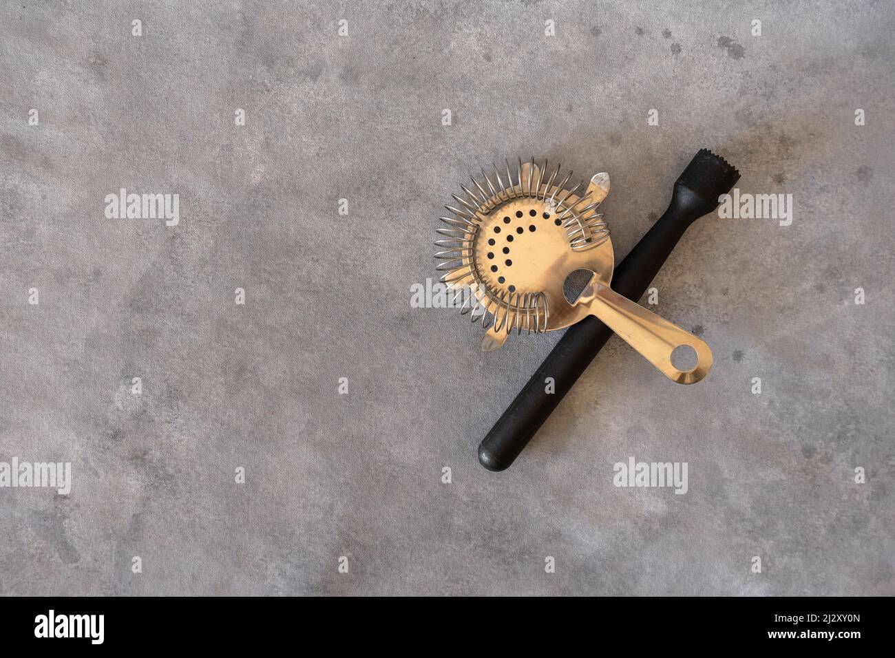 Strainer and mortar for cocktails. Top view on gray background Stock ...