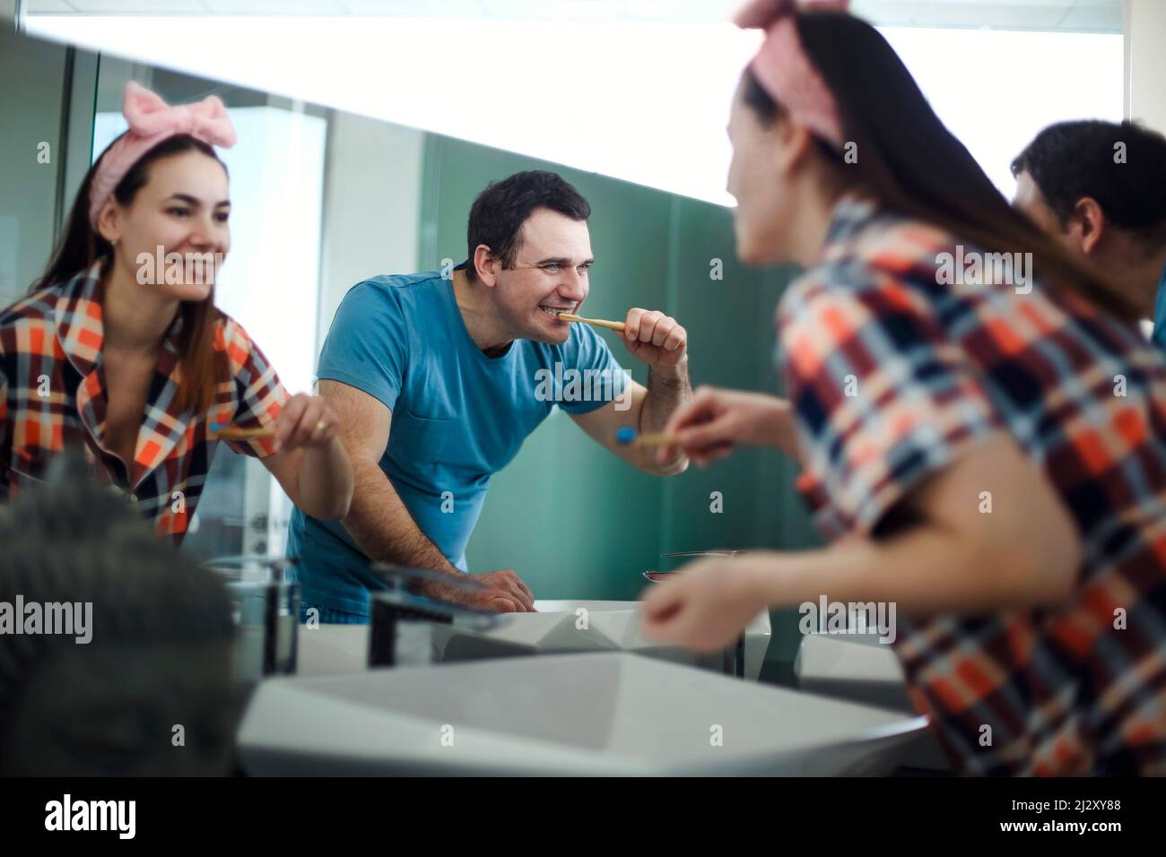 Happy Young brunette Couple Brushing Teeth In Bathroom, Loving Man and ...