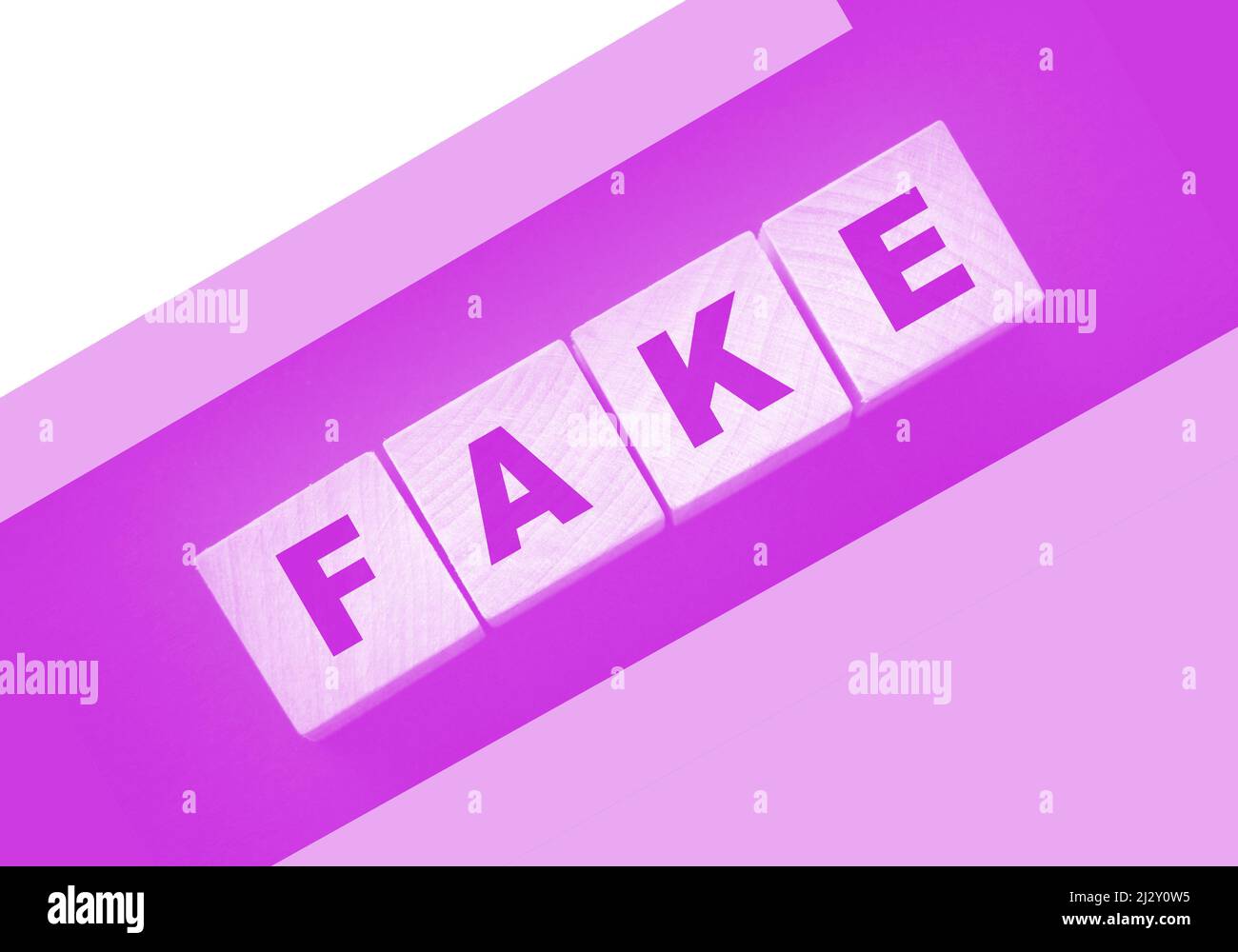 FAKE word written in wooden blocks on black background Stock Photo - Alamy