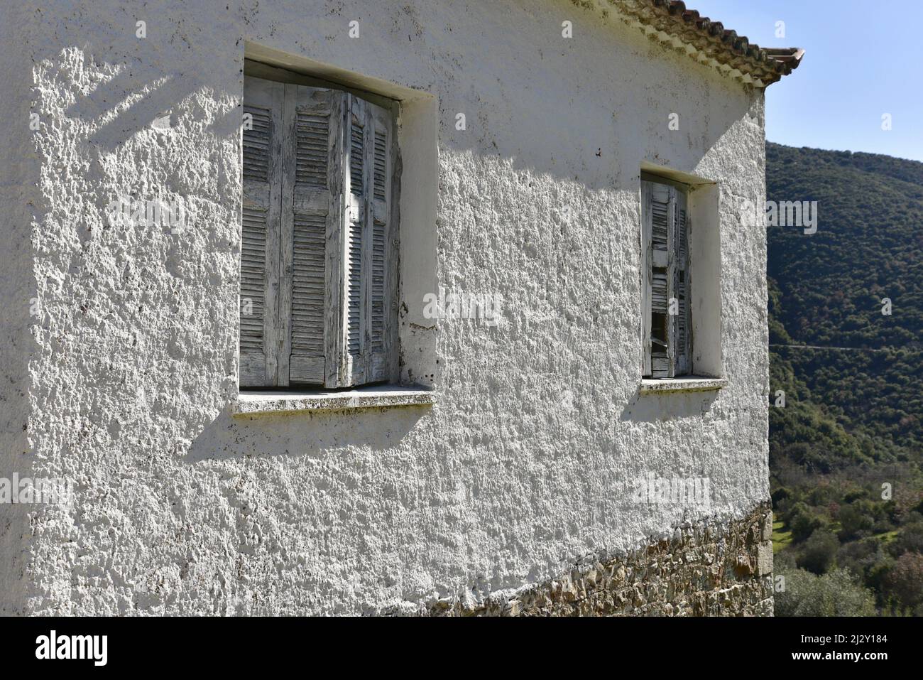 Old traditional rural house with a whitewashed stone wall, wooden ...