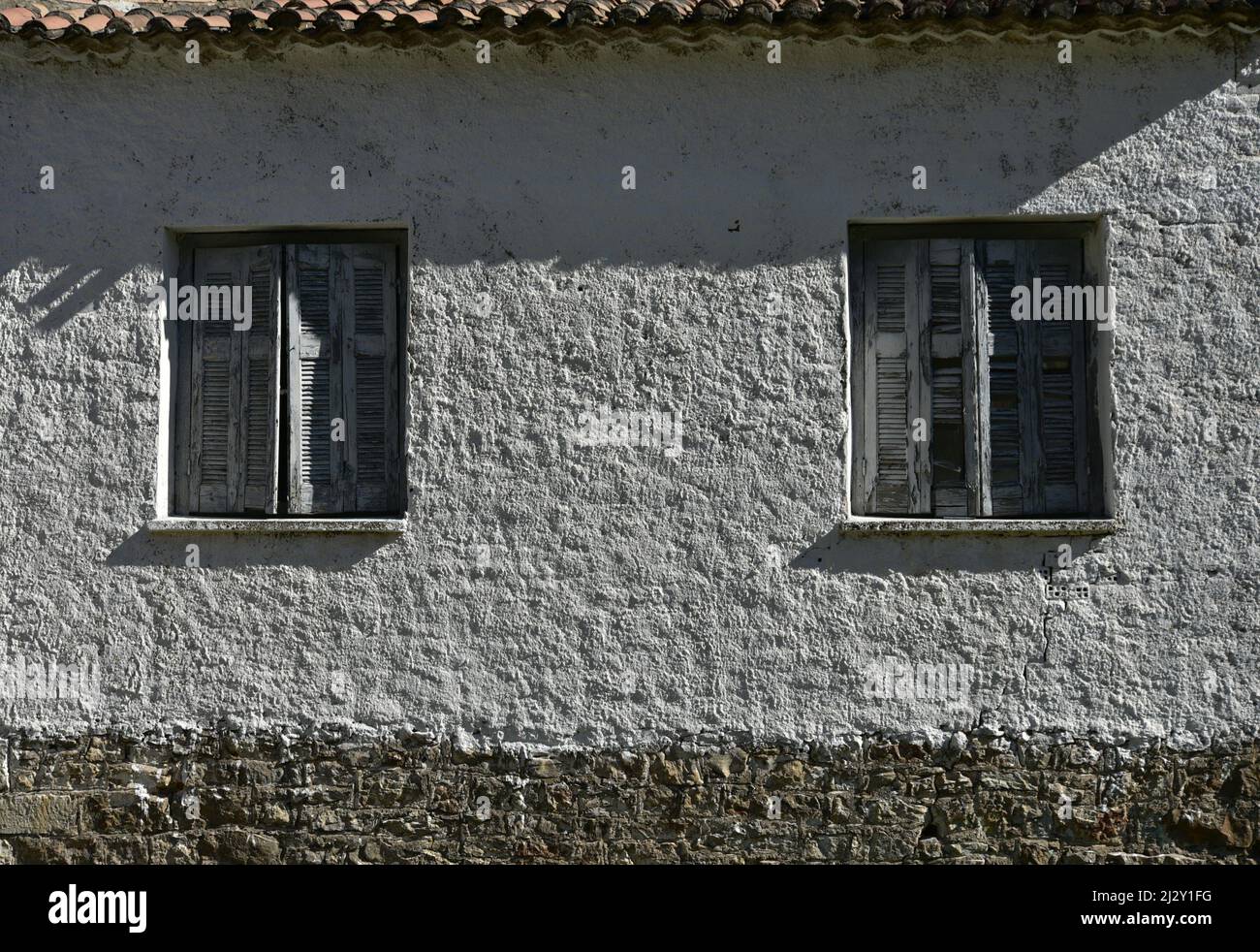 Old traditional rural house facade with a whitewashed stone wall ...