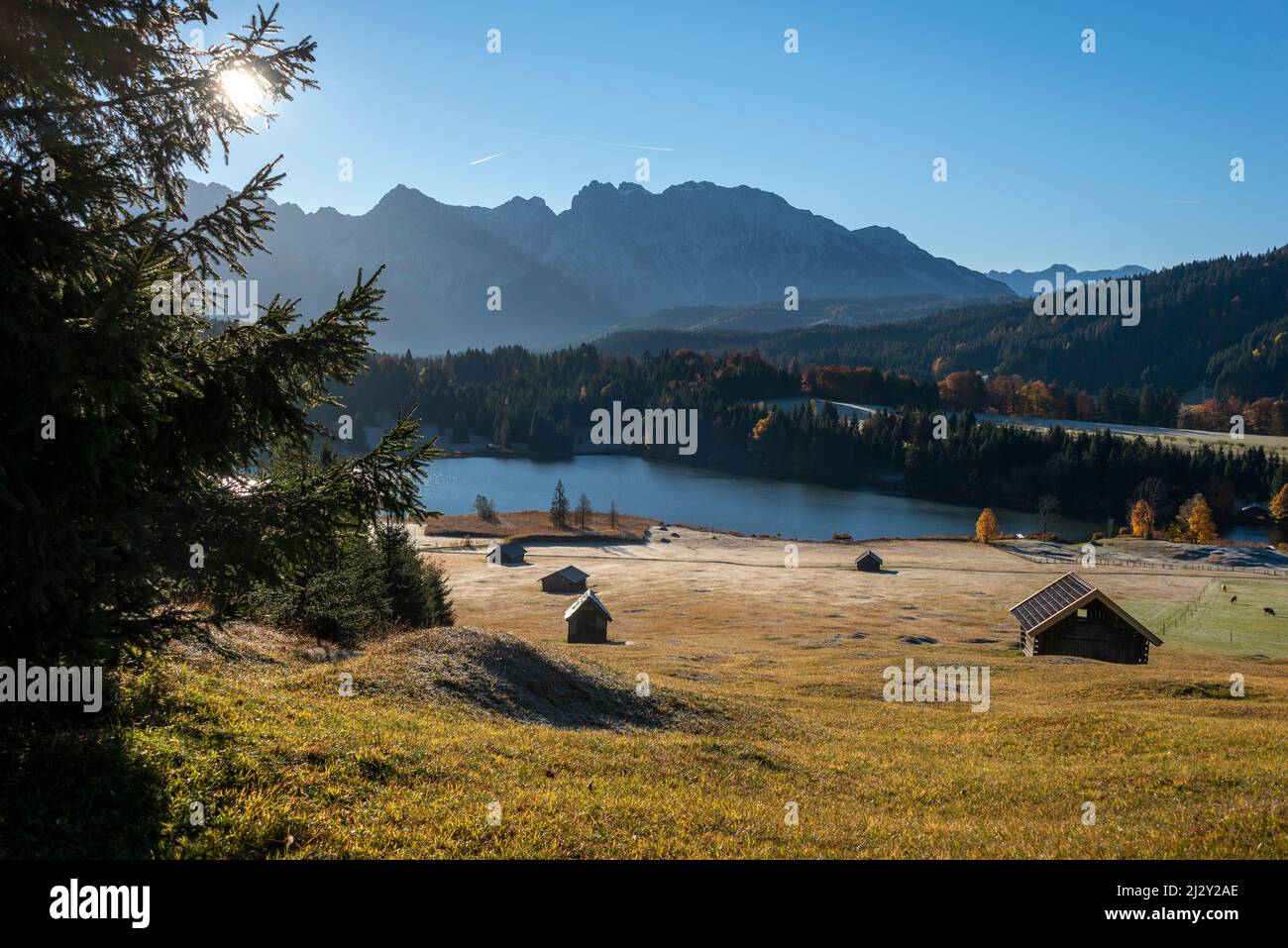 Sunrise at Geroldsee, humpback meadows with hoar frost, hay barn ...