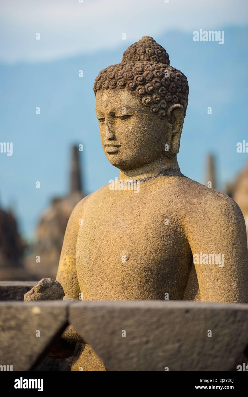 Side portrait of buddha statue at buddhist temple Borobudur, Java ...