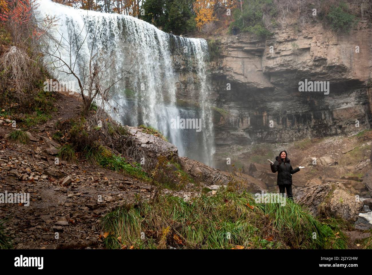 Tourist standing at the foot of Webster's Falls in Southern Ontario ...