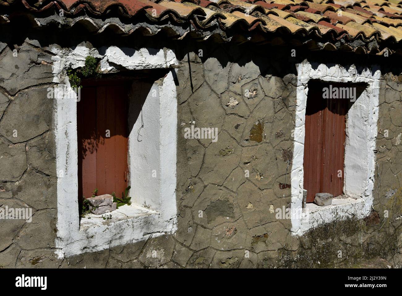 Old traditional rural house with a clay tile rooftop antique windows ...