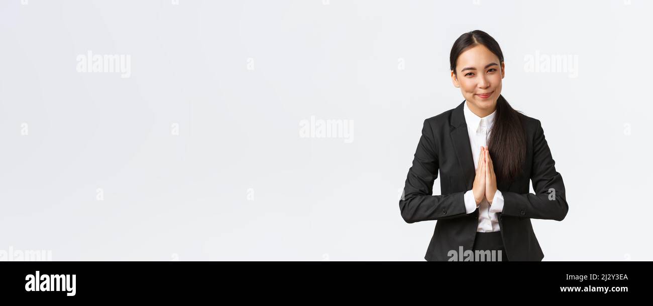 Friendly asian businesswoman hold hands together and bowing at business ...