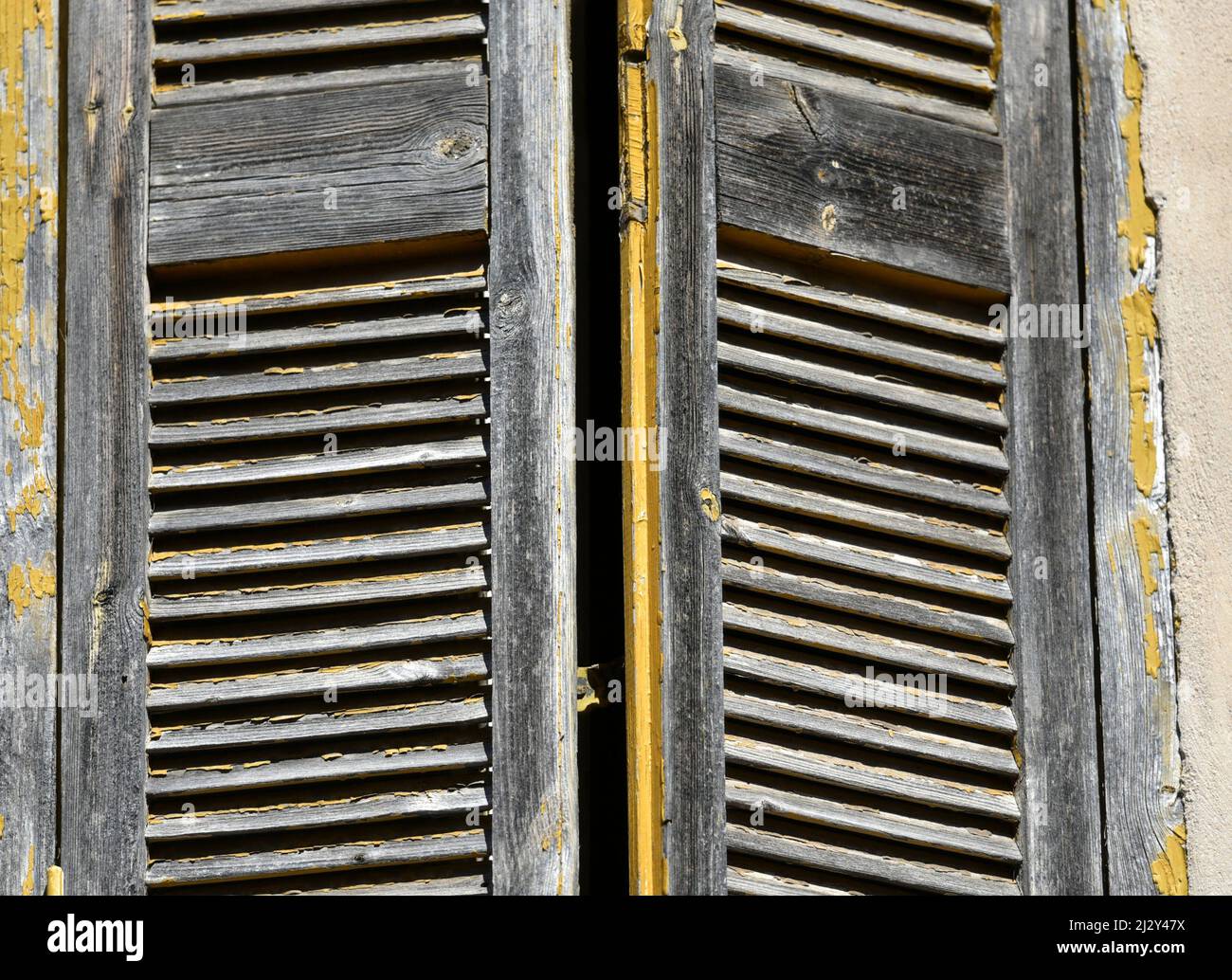 Old traditional rural house antique weathered wooden window shutters in ...