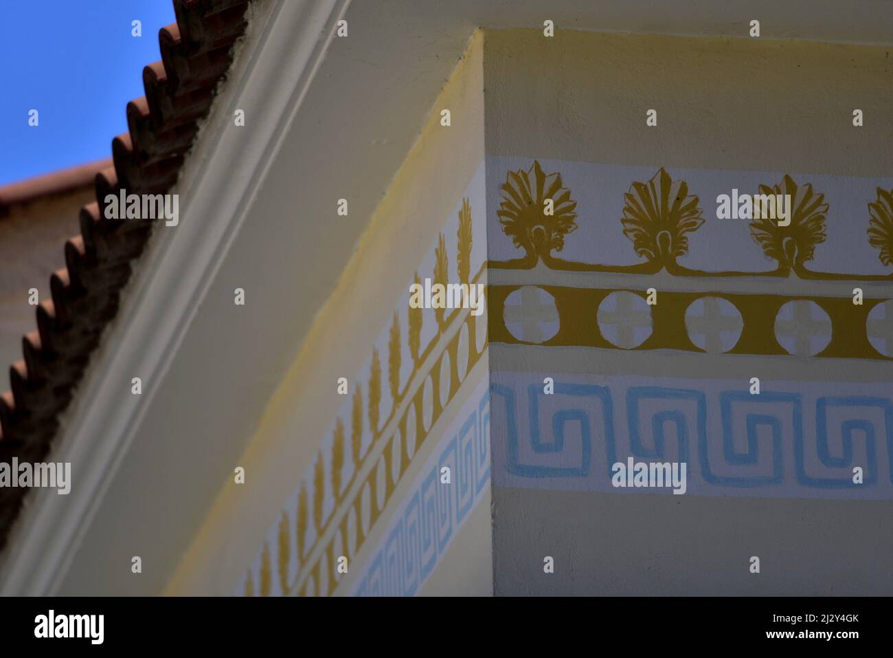 Neoclassical mansion with a red clay tile rooftop and an ochre wall ...