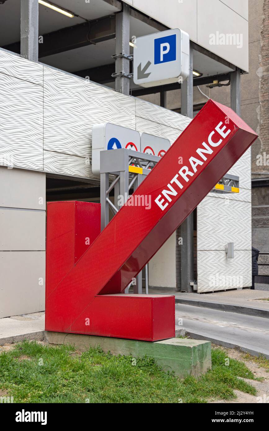 Big Red Arrow Sign Entrance to Parking Garage Stock Photo - Alamy
