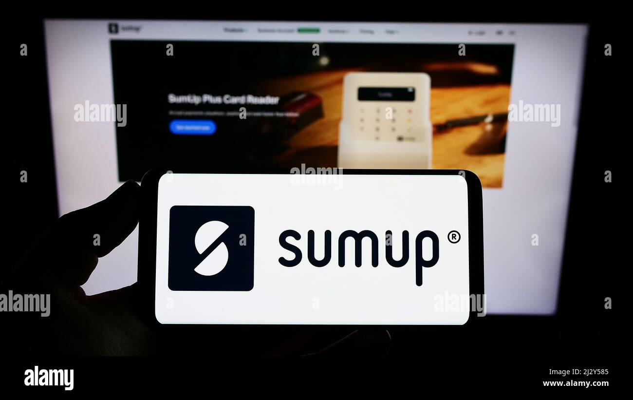 Person holding smartphone with logo of British fintech company SumUp ...