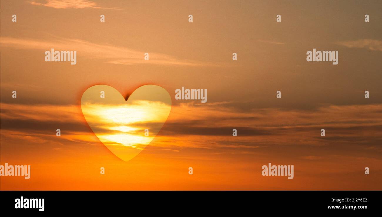heart against the background of the sunset sky, love symbol in orange ...