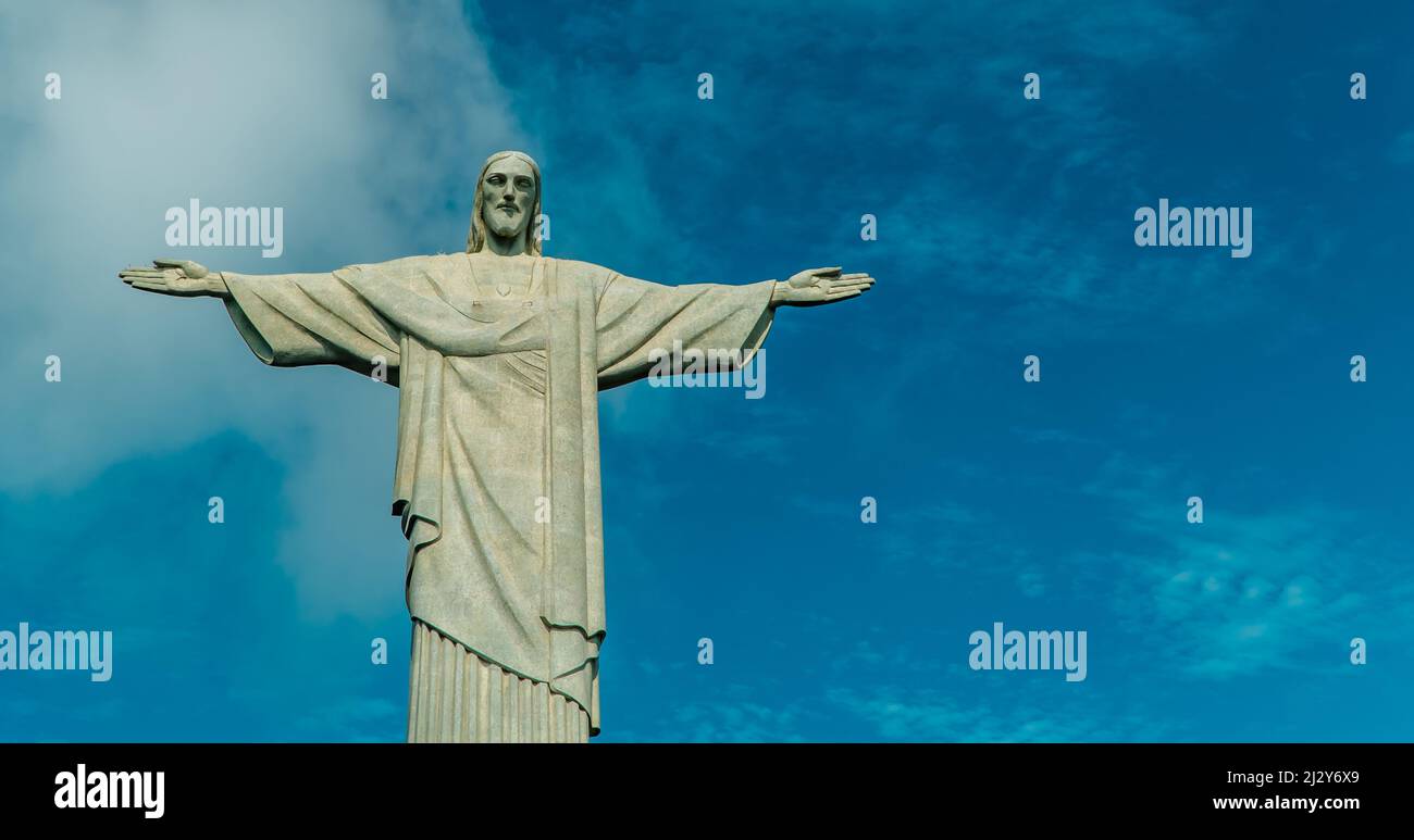 A low angle shot of the Christ the Redeemer statue in a blue sky in Rio ...