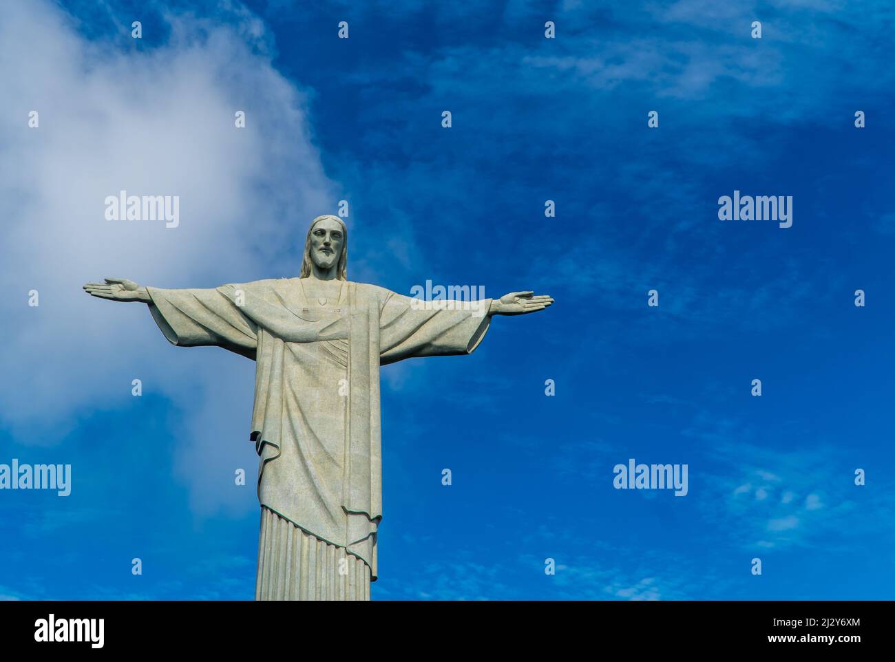 A low angle shot of the Christ the Redeemer statue in a blue sky in Rio ...