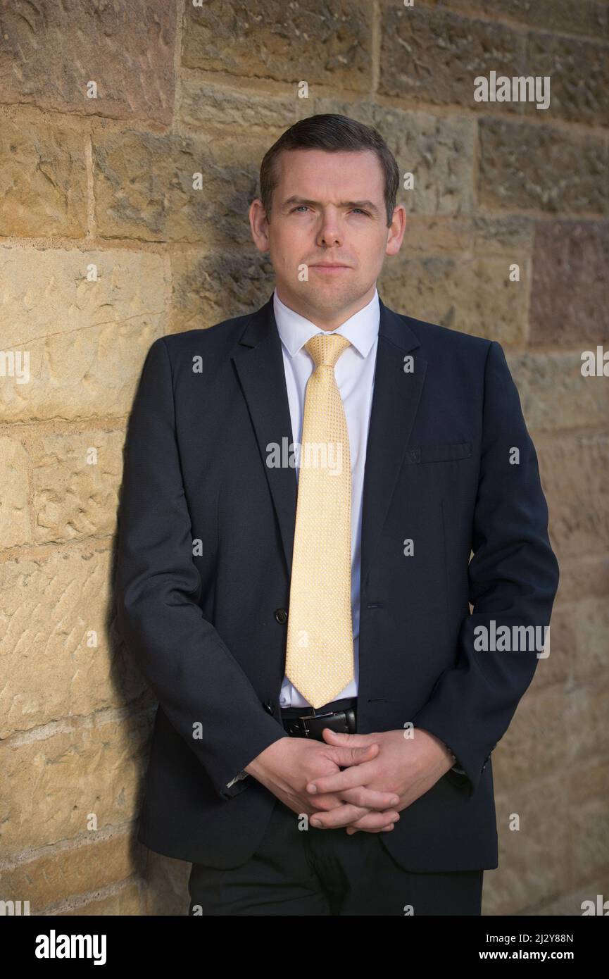 Douglas ross in dark suit with sandstone wall backdrop hi-res stock ...