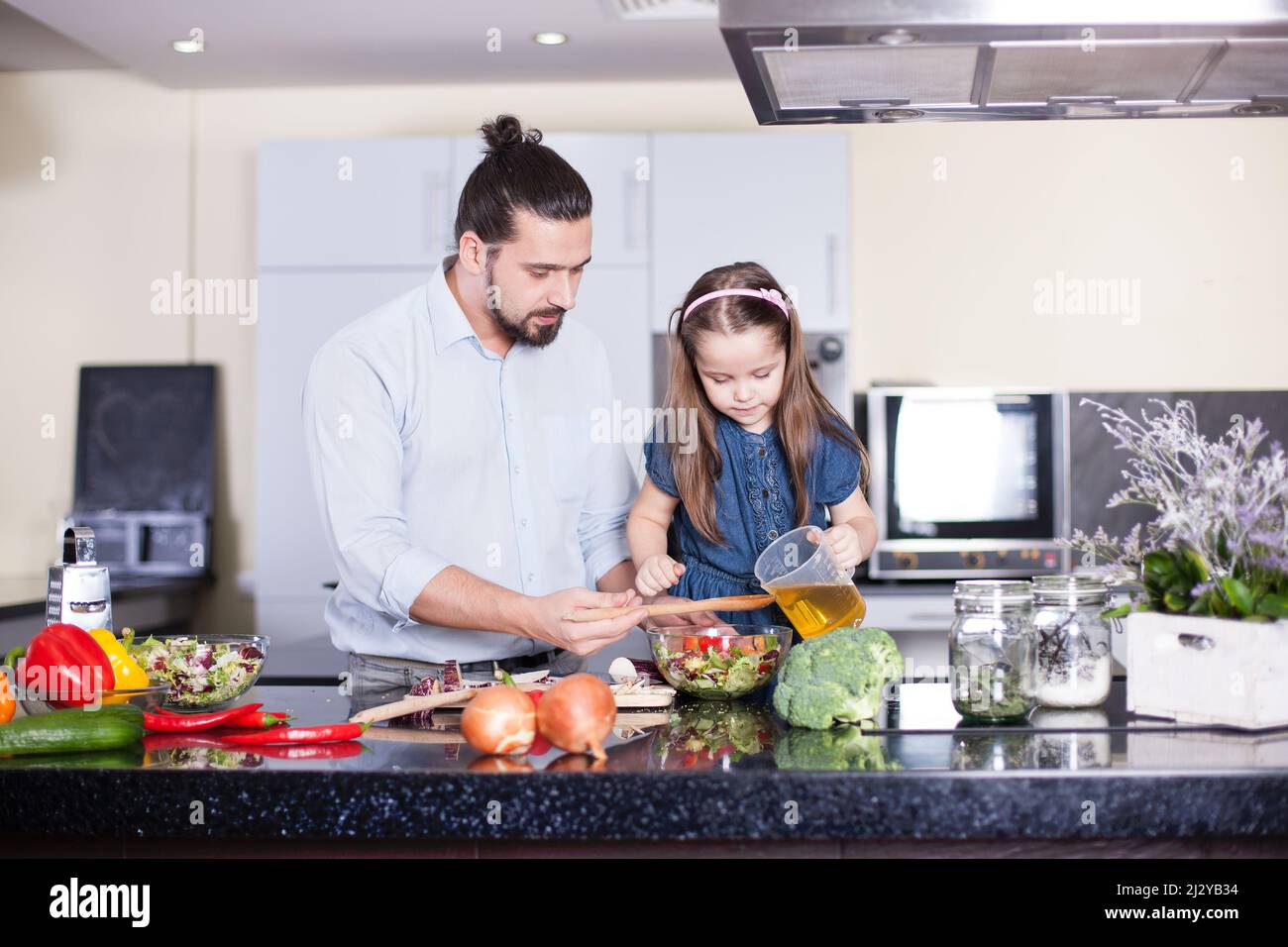 Father and children cooking dinner hi-res stock photography and images ...
