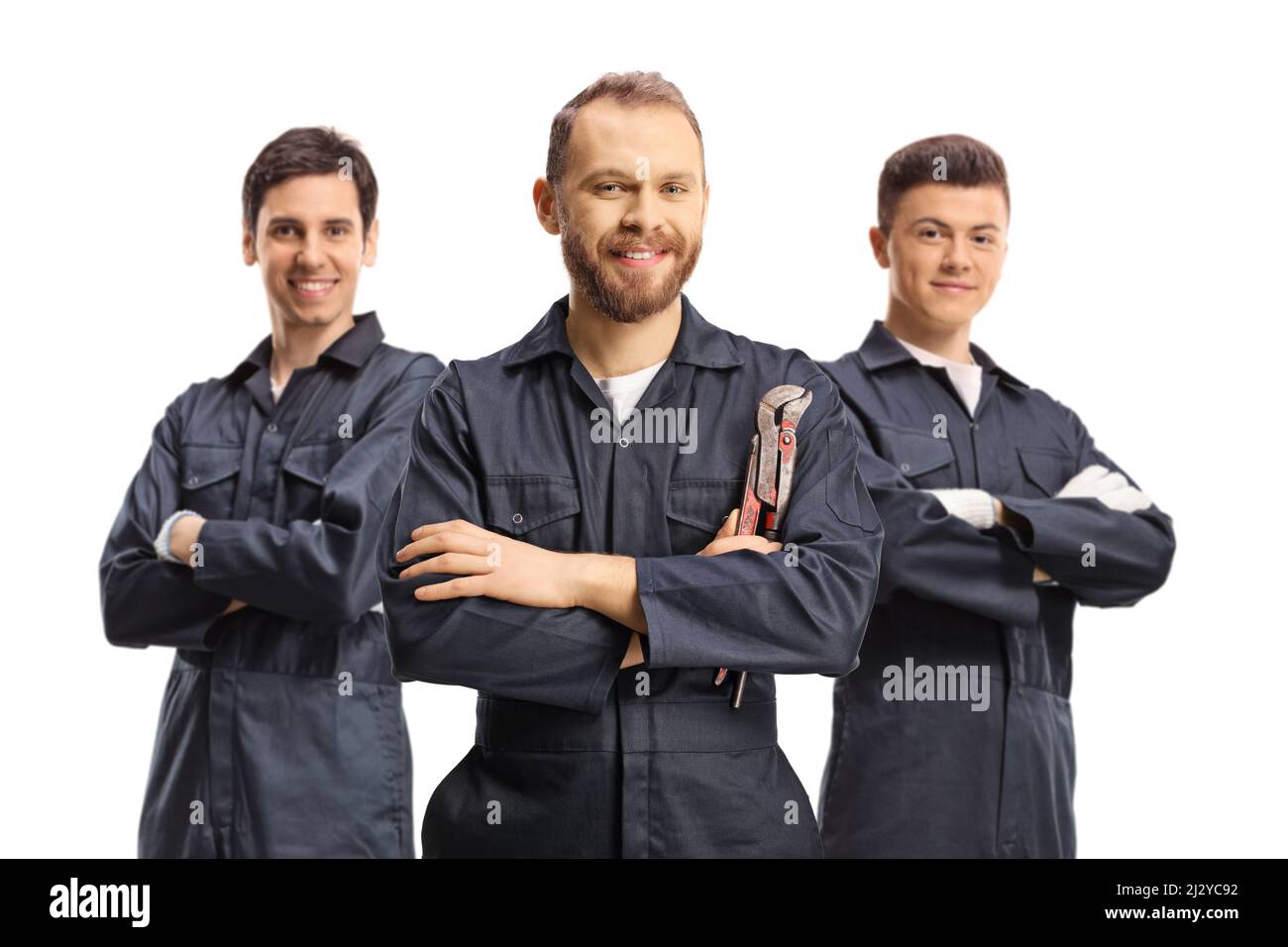 Team of plumbers in uniforms looking at camera isolated on white ...