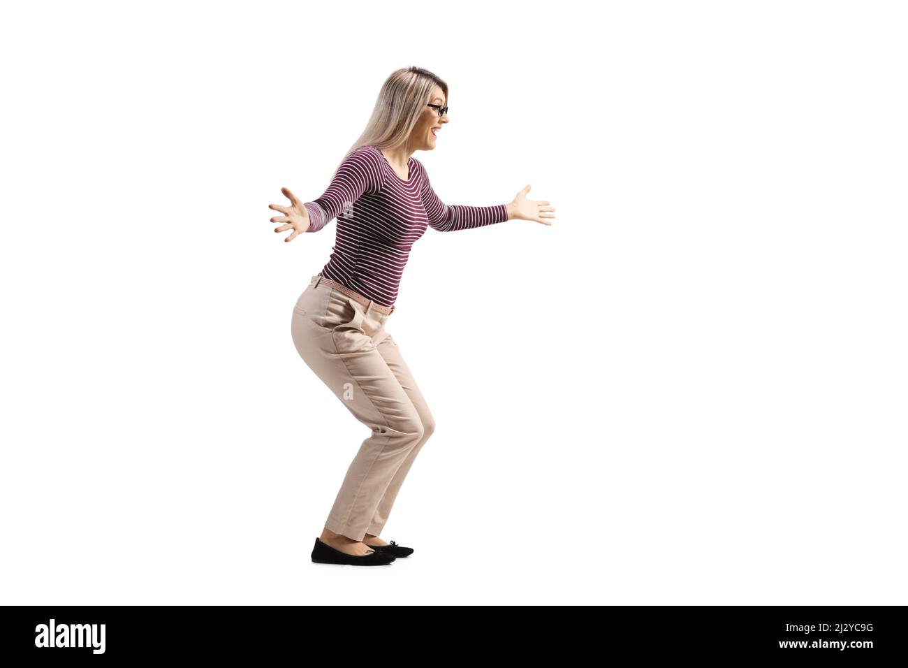 Full length profile shot of a happy young woman waiting with arms wide ...