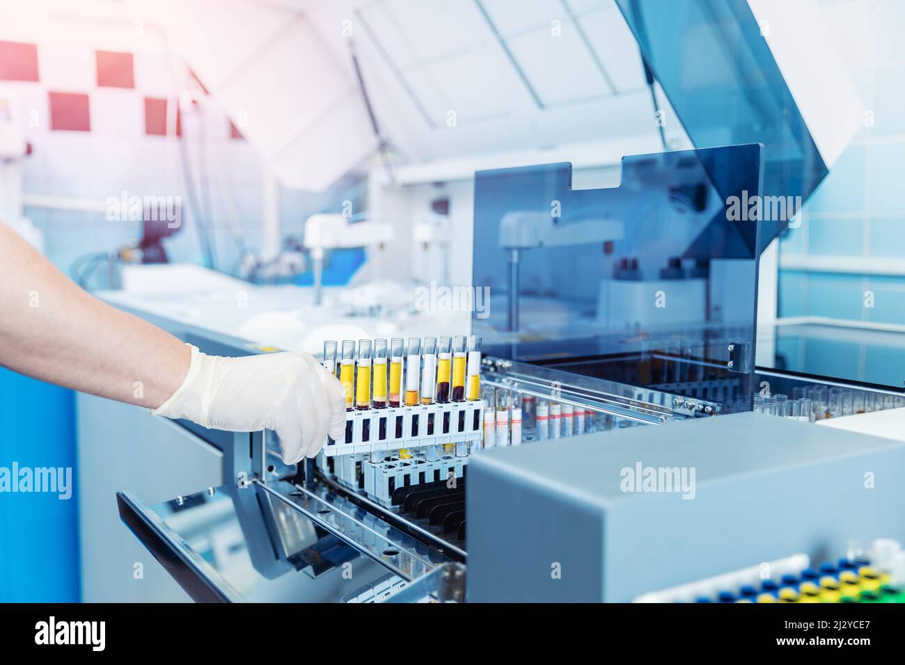 Scientist working with auto robotical machine for testing blood, modern ...