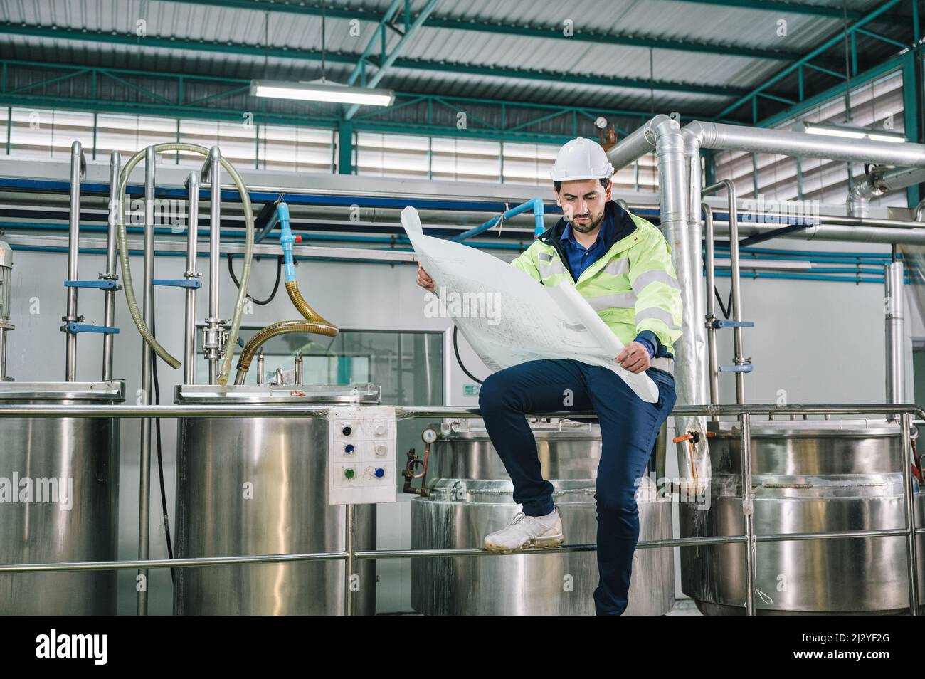Caucasian technician engineer man in uniform sitting and holding ...